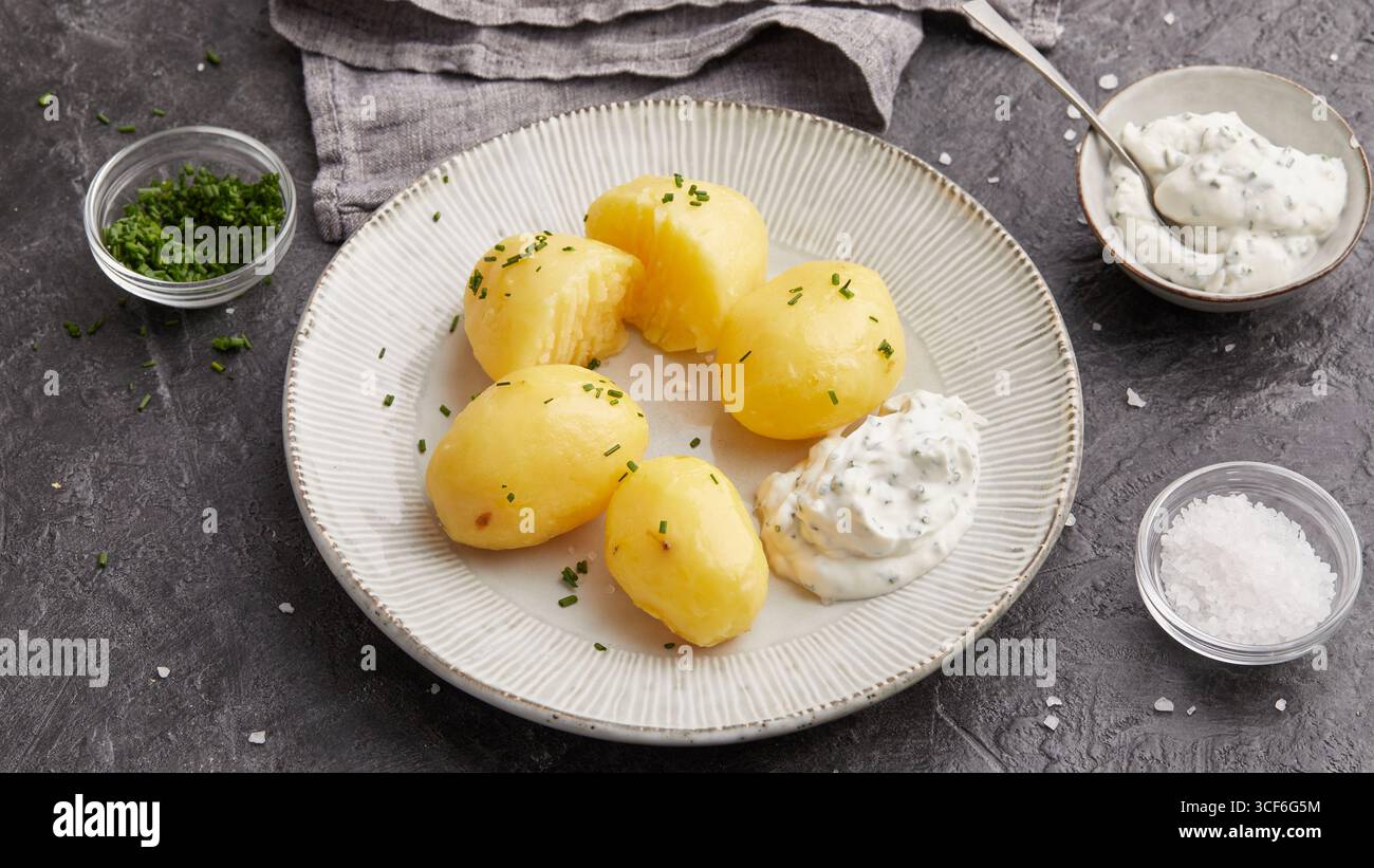 Boiled potatoes with chive dip Stock Photo - Alamy