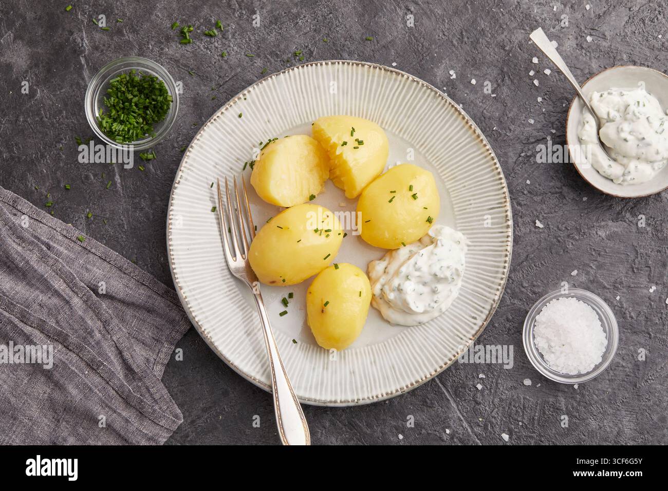 Boiled potatoes with chive dip Stock Photo - Alamy