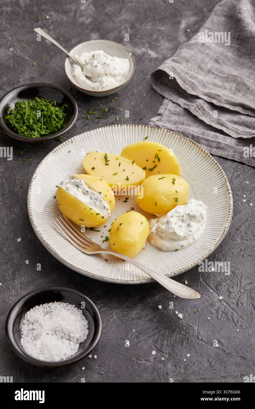Boiled potatoes with chive dip Stock Photo - Alamy