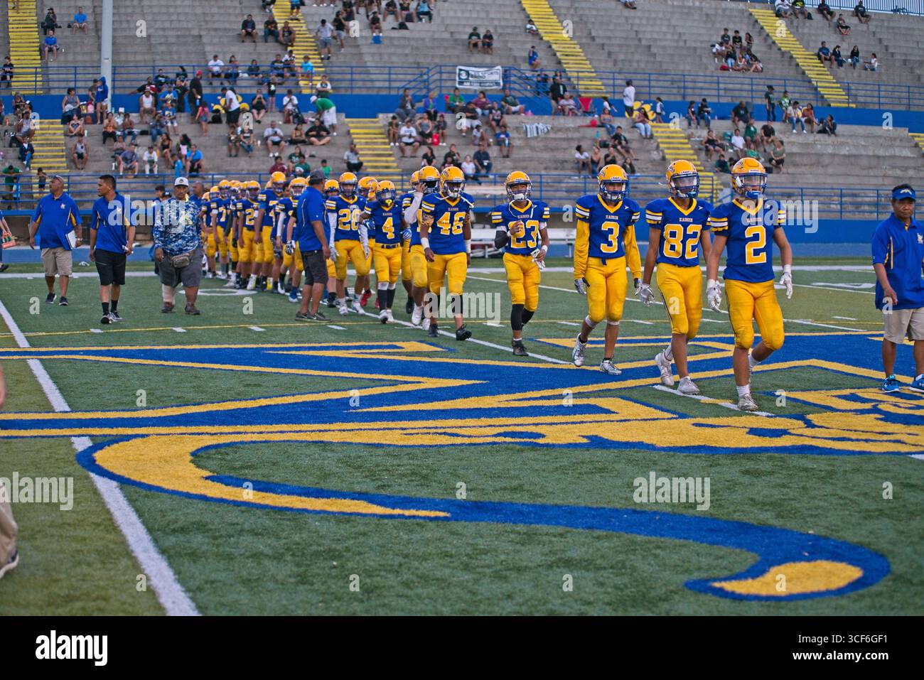 Post-game respect on the gridiron—Kaiser High School players line up ...