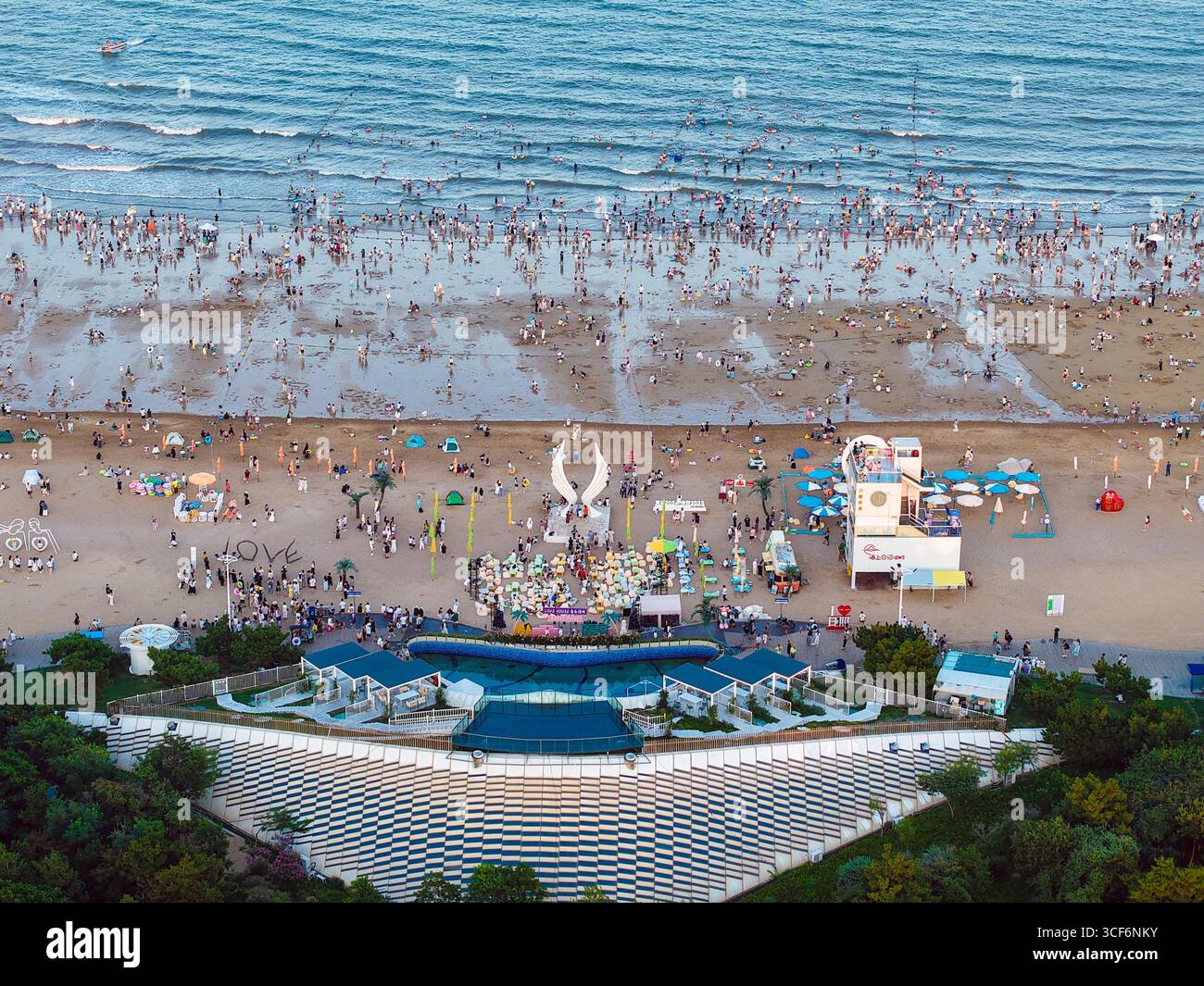 People go beachcombing in Rizhao City, east China's Shandong Province ...
