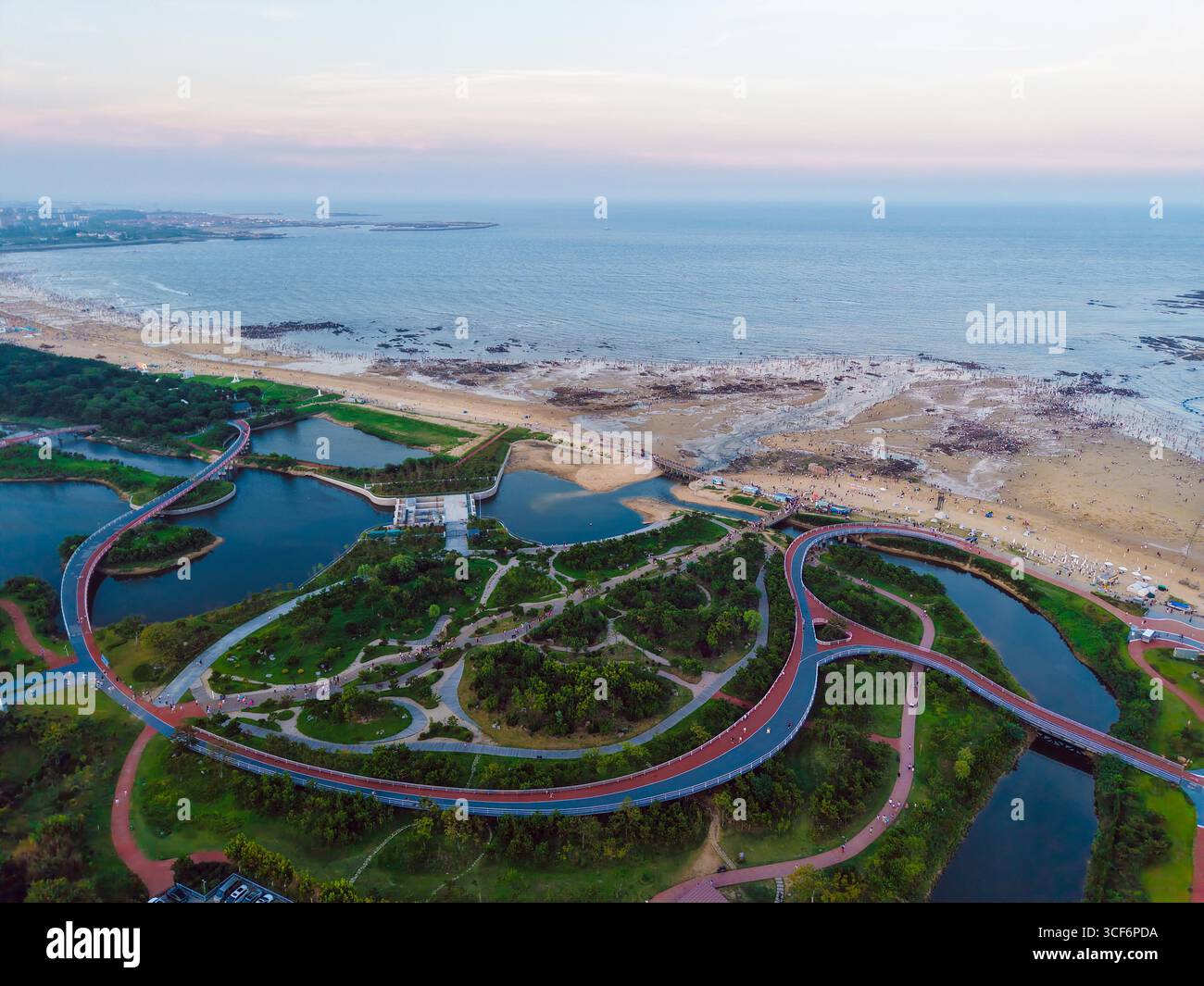 People go beachcombing in Rizhao City, east China's Shandong Province ...