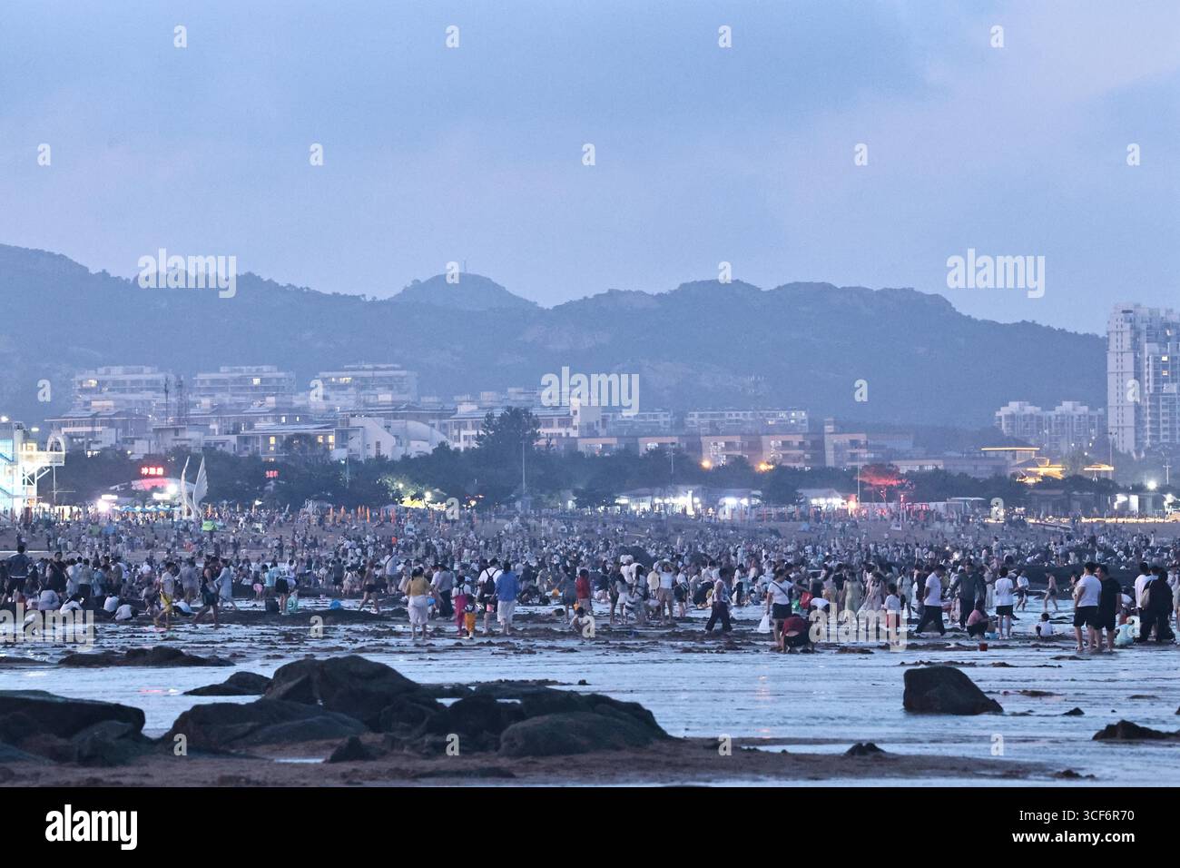 People go beachcombing in Rizhao City, east China's Shandong Province ...