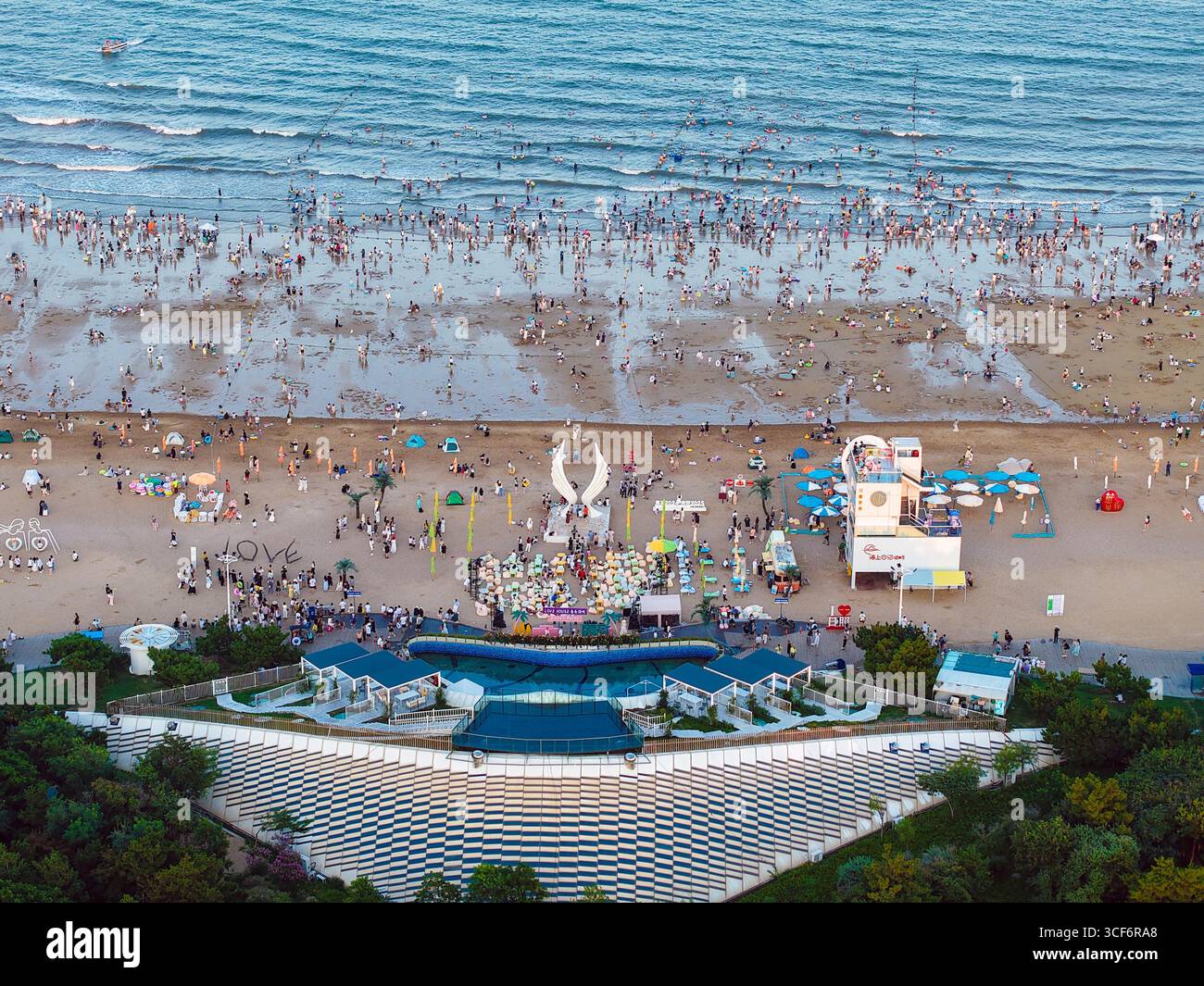 People go beachcombing in Rizhao City, east China's Shandong Province ...