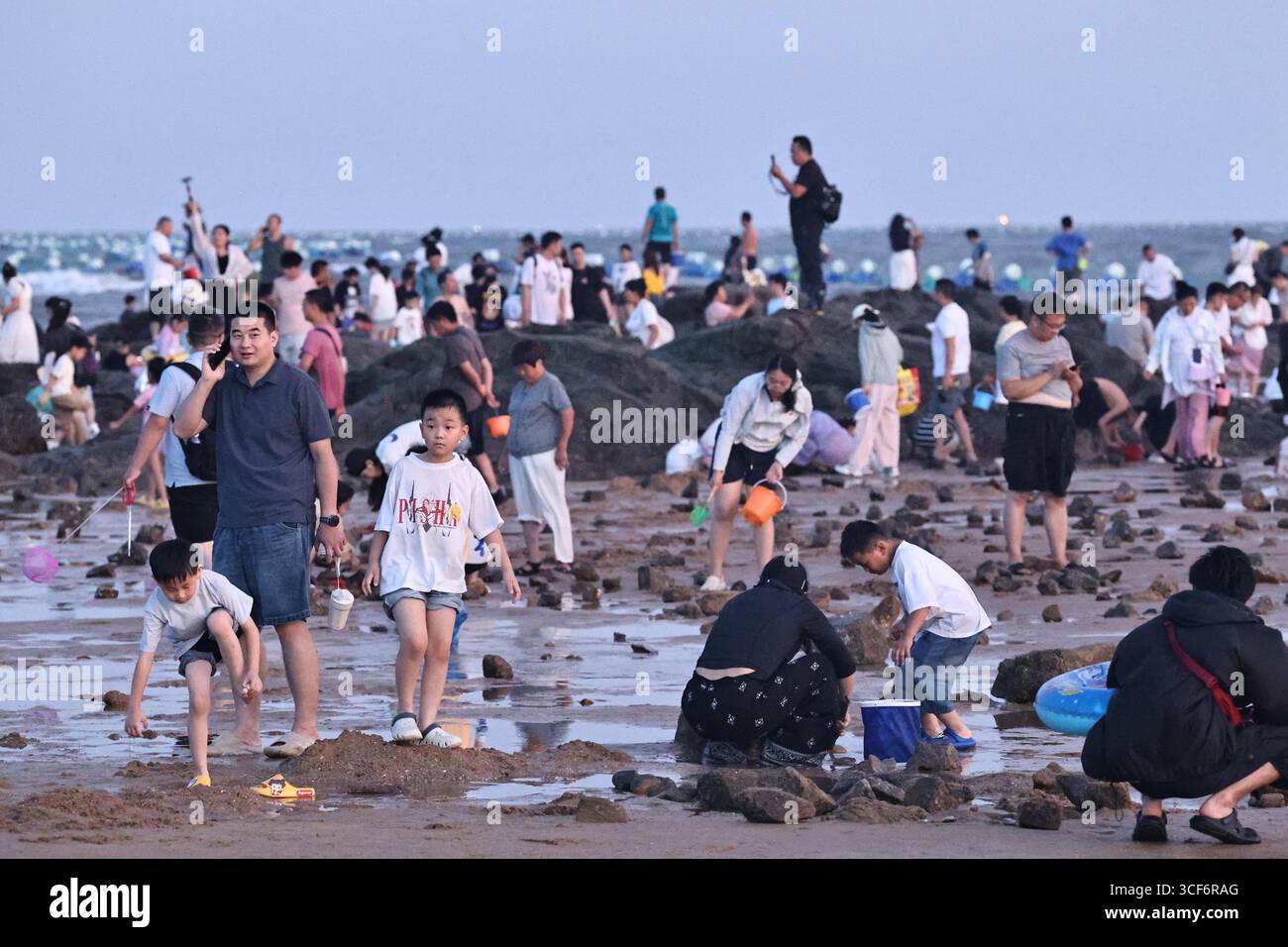 People go beachcombing in Rizhao City, east China's Shandong Province ...