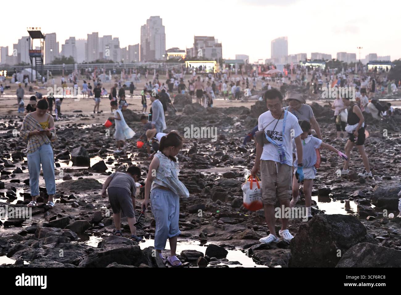 People go beachcombing in Rizhao City, east China's Shandong Province ...