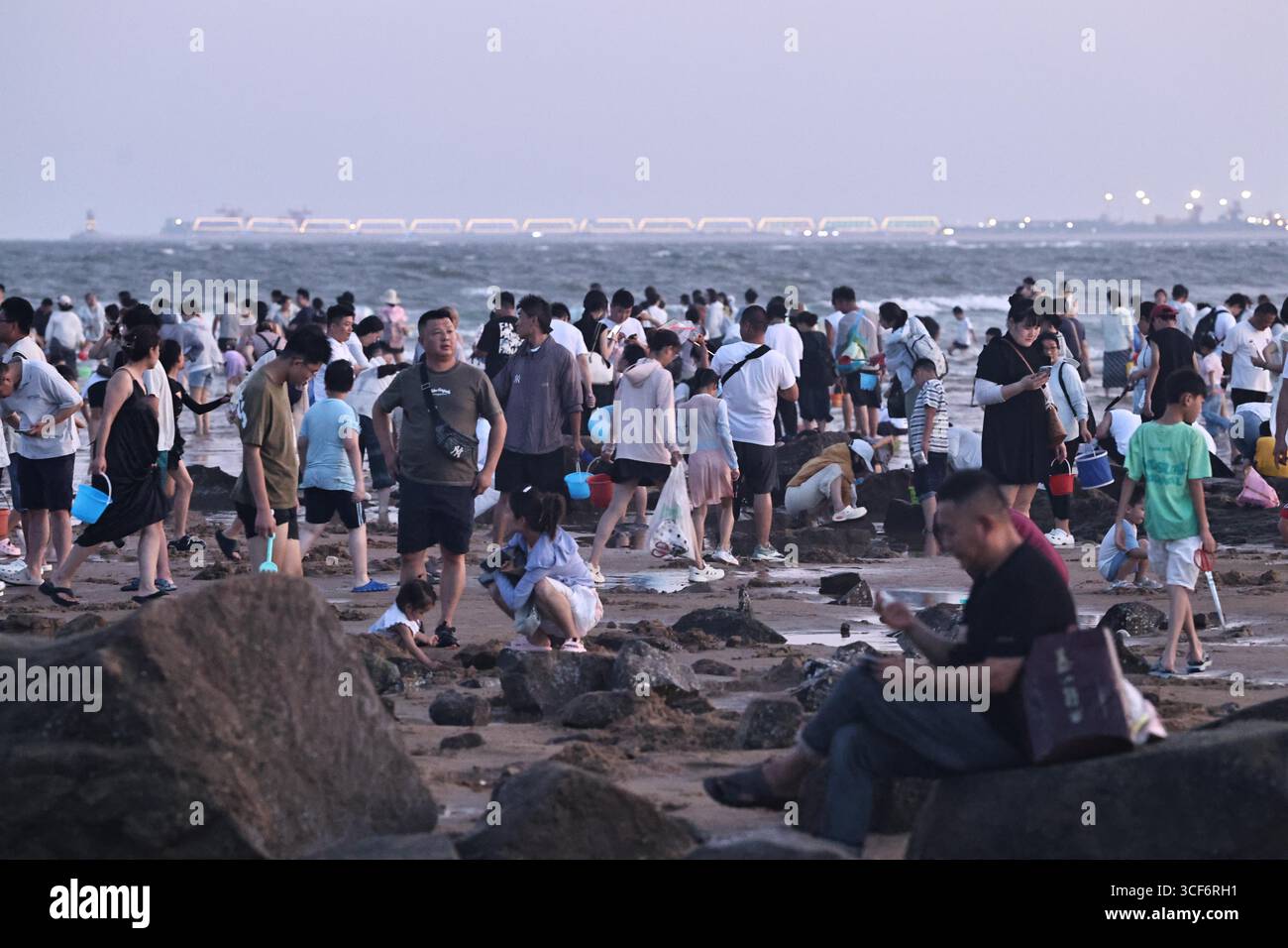 People go beachcombing in Rizhao City, east China's Shandong Province ...