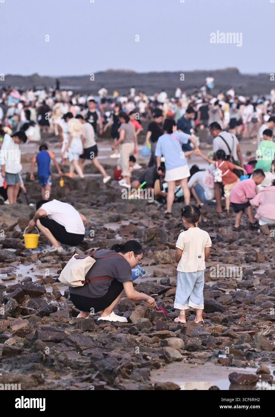 People go beachcombing in Rizhao City, east China's Shandong Province ...