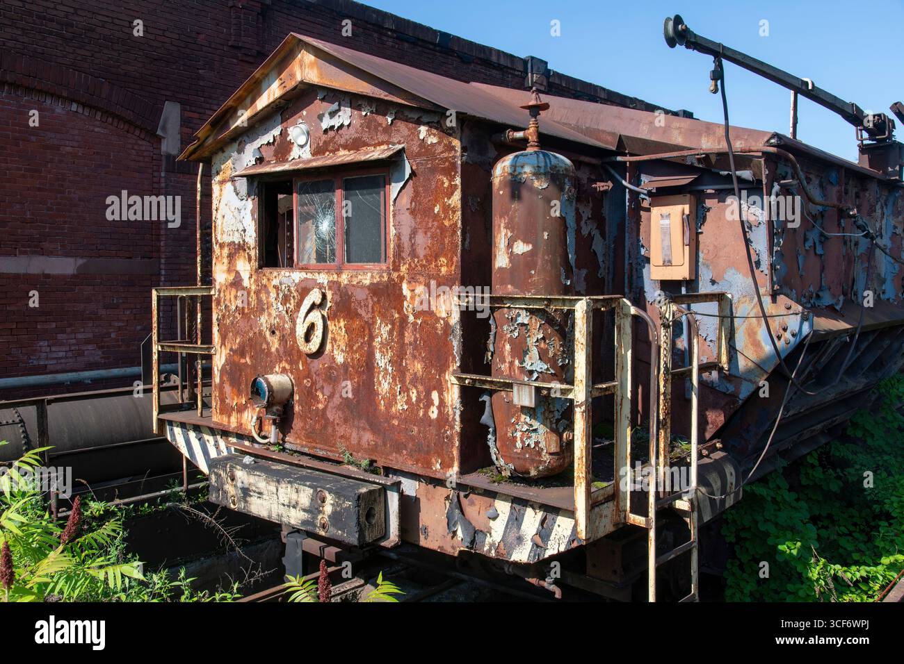 Rusty industrial locomotive at abandoned and dilapidated remnants like ...