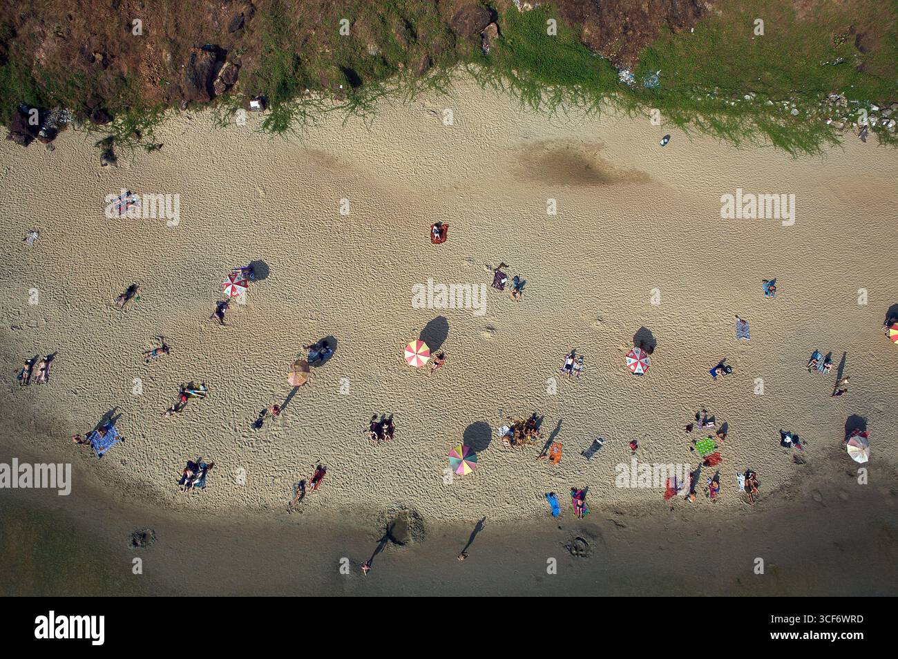 Aerial view of the shoreline where golden sands meet the azure sea ...