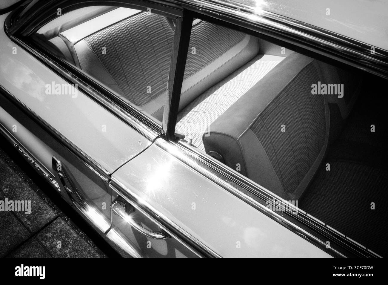 Interior of a classic car with hounds tooth upholstery in black and ...