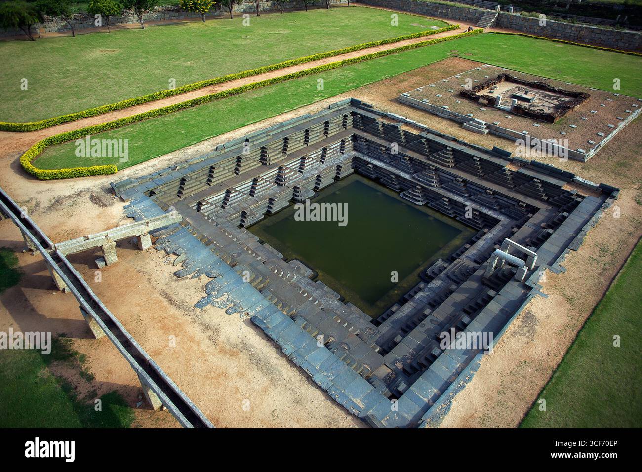 Aerial view of the stepped square Pushkarani tank, its dark waters ...