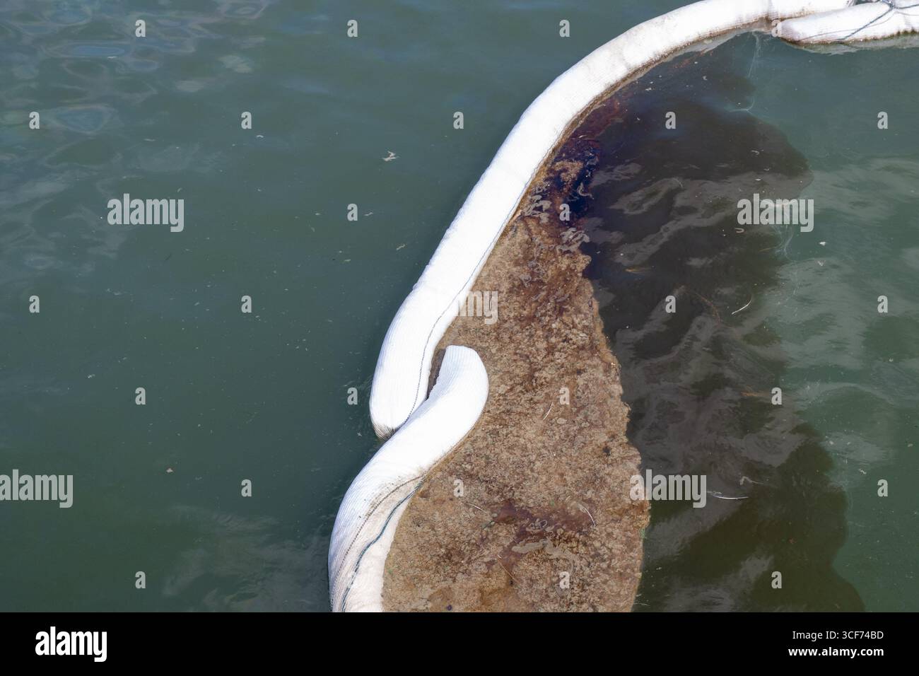 Part of the oil spill is seen as shipping traffic on the Albert Canal ...