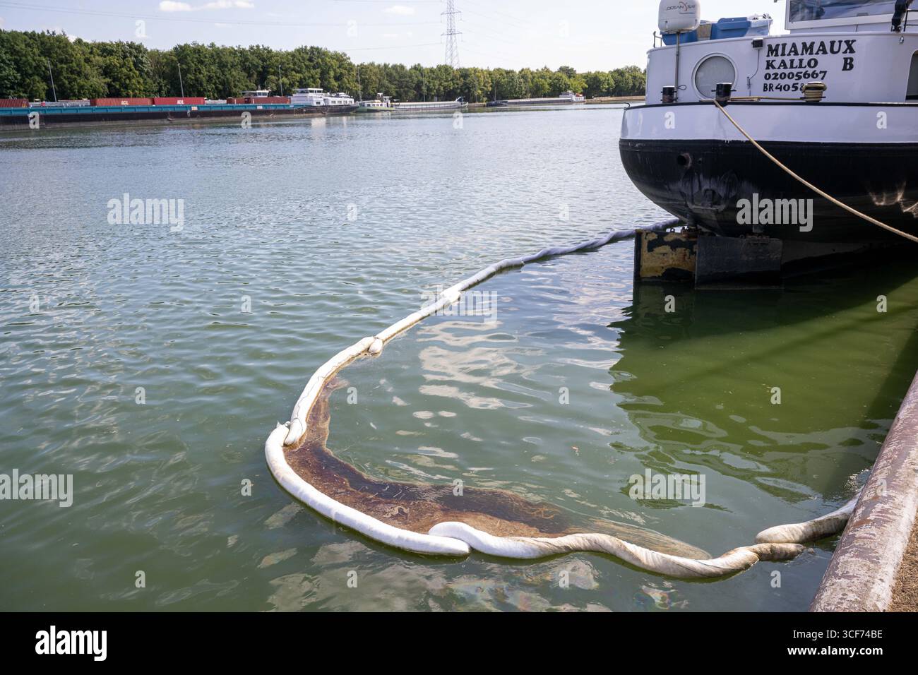 Part of the oil spill is seen as shipping traffic on the Albert Canal ...