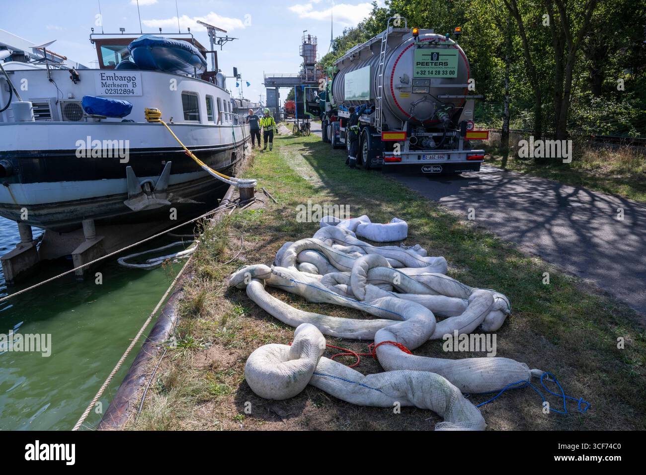 Clean up efforts are seen as shipping traffic on the Albert Canal near ...