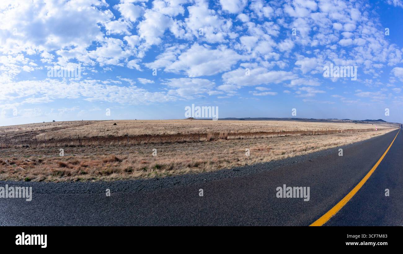 Travel road highway driving through wide open expanse of semi arid bush ...