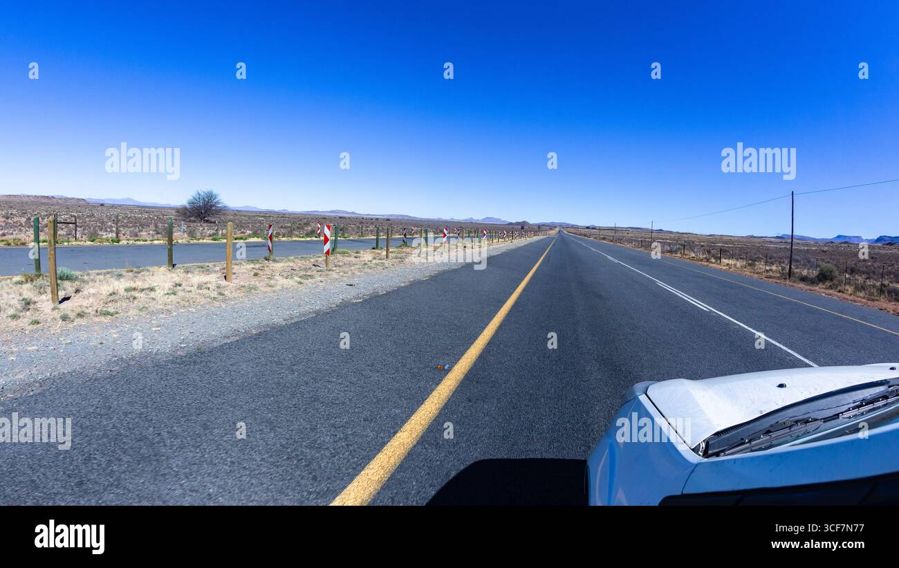 Travel road highway driving through wide open expanse of semi arid bush ...