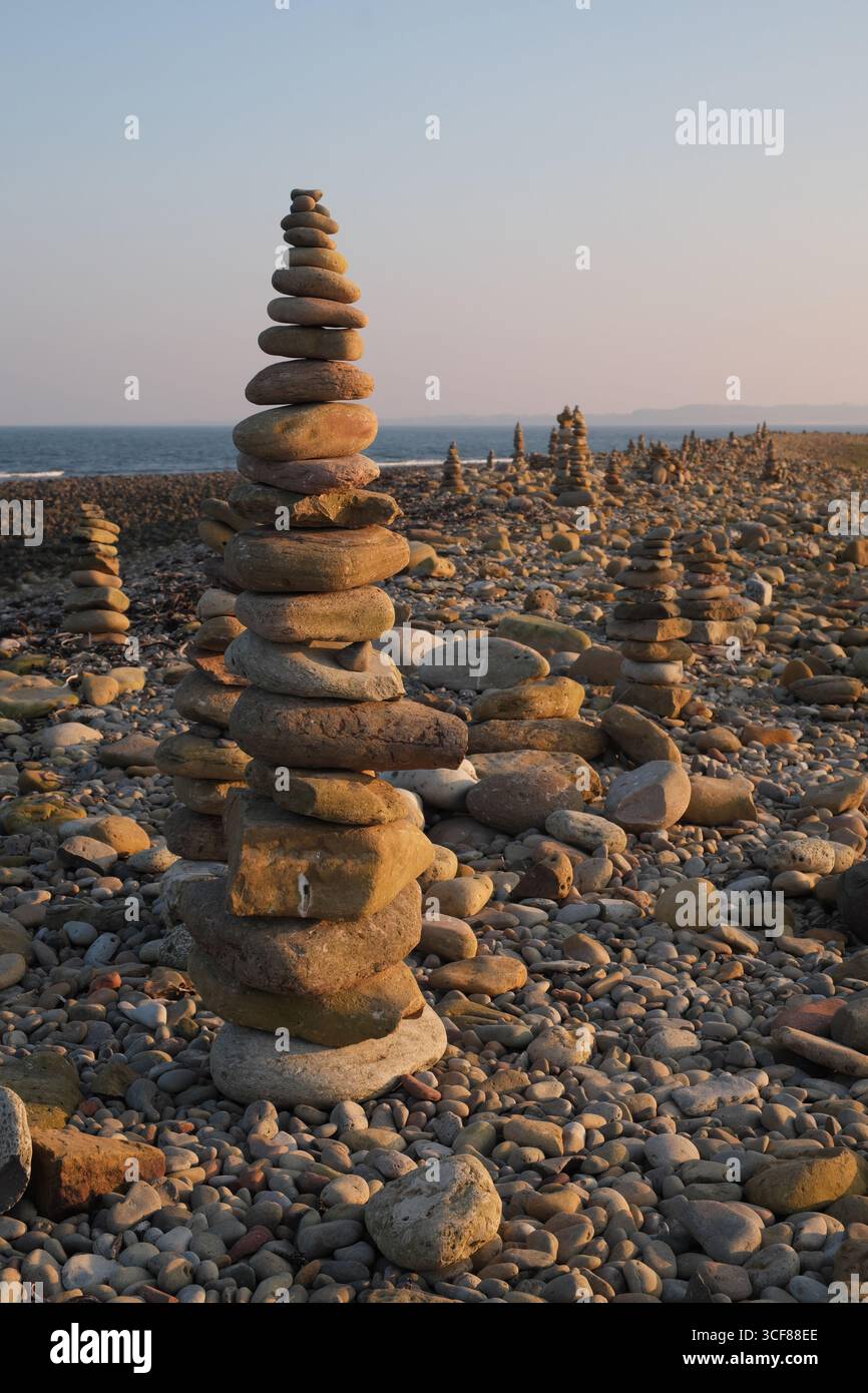 Towers of stones on a beach, Holy Island, Northumberland, England, UK ...