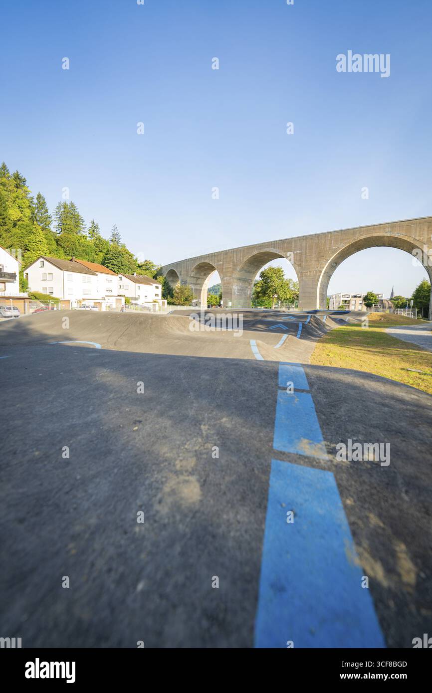 Asphalt track with blue markings, topped by an arched bridge, Nagold ...