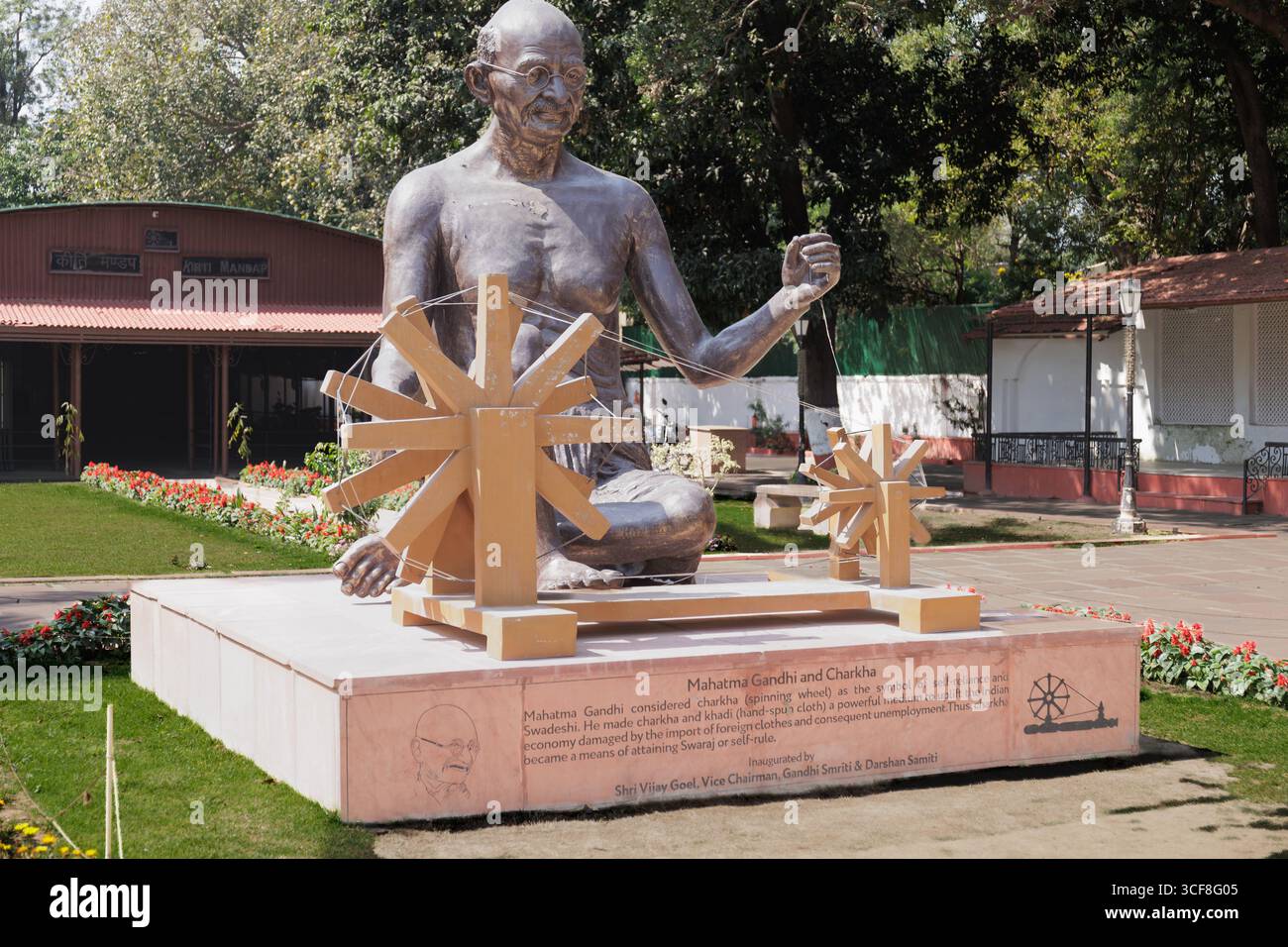 Statue of Gandhi with his weaving loom at Raj Ghat Stock Photo - Alamy