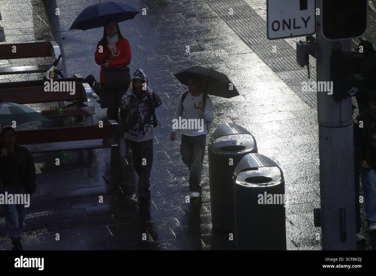 Sydney, NSW, Australia. 21st August 2025. People with umbrellas on ...