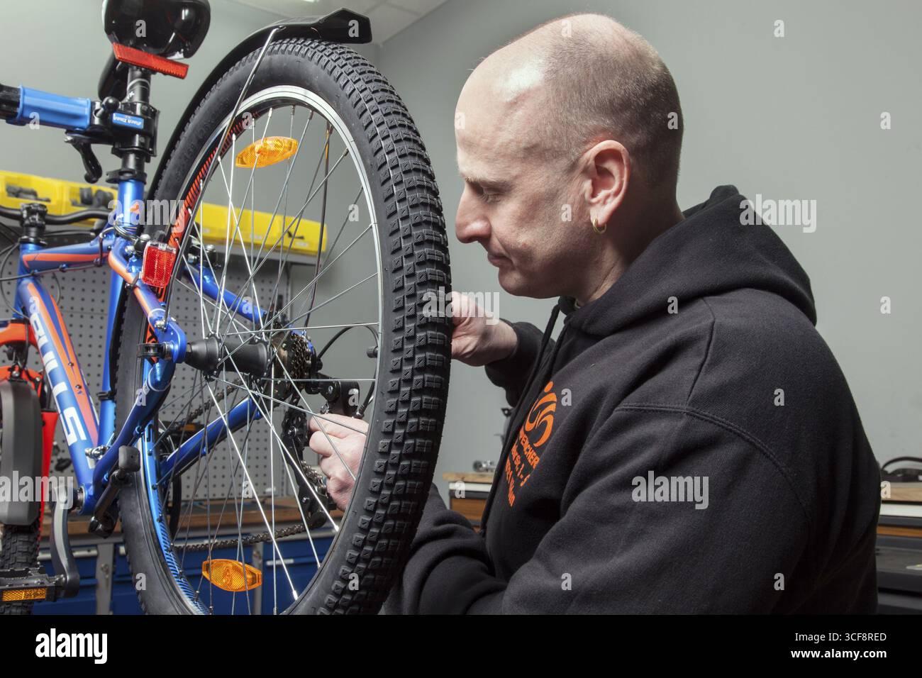 Bike mechanic in the bike workshop during an inspection on a mountain ...