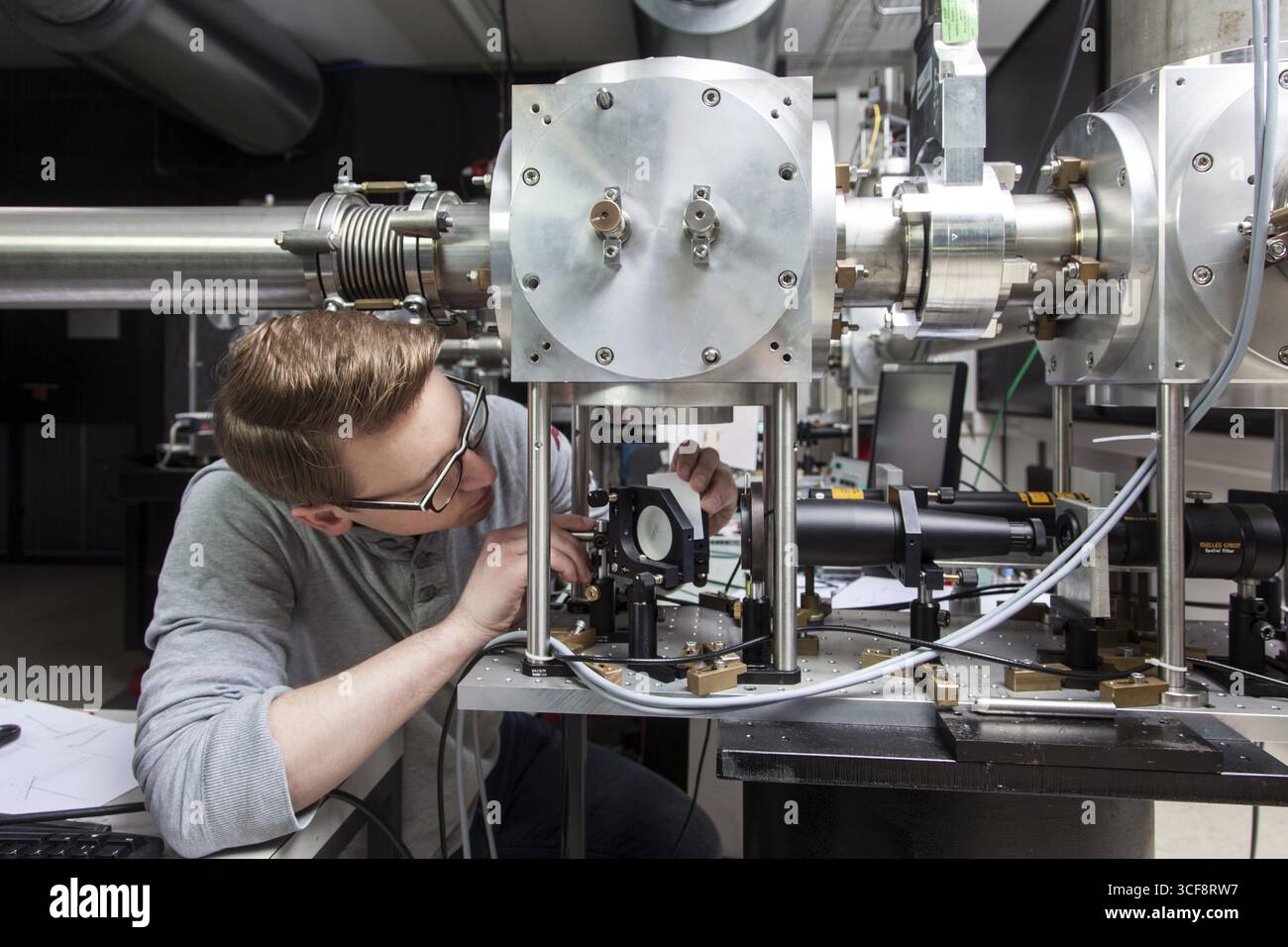 PhD student during his research work adjusting his experimental setup, laser laboratory of Prof ...
