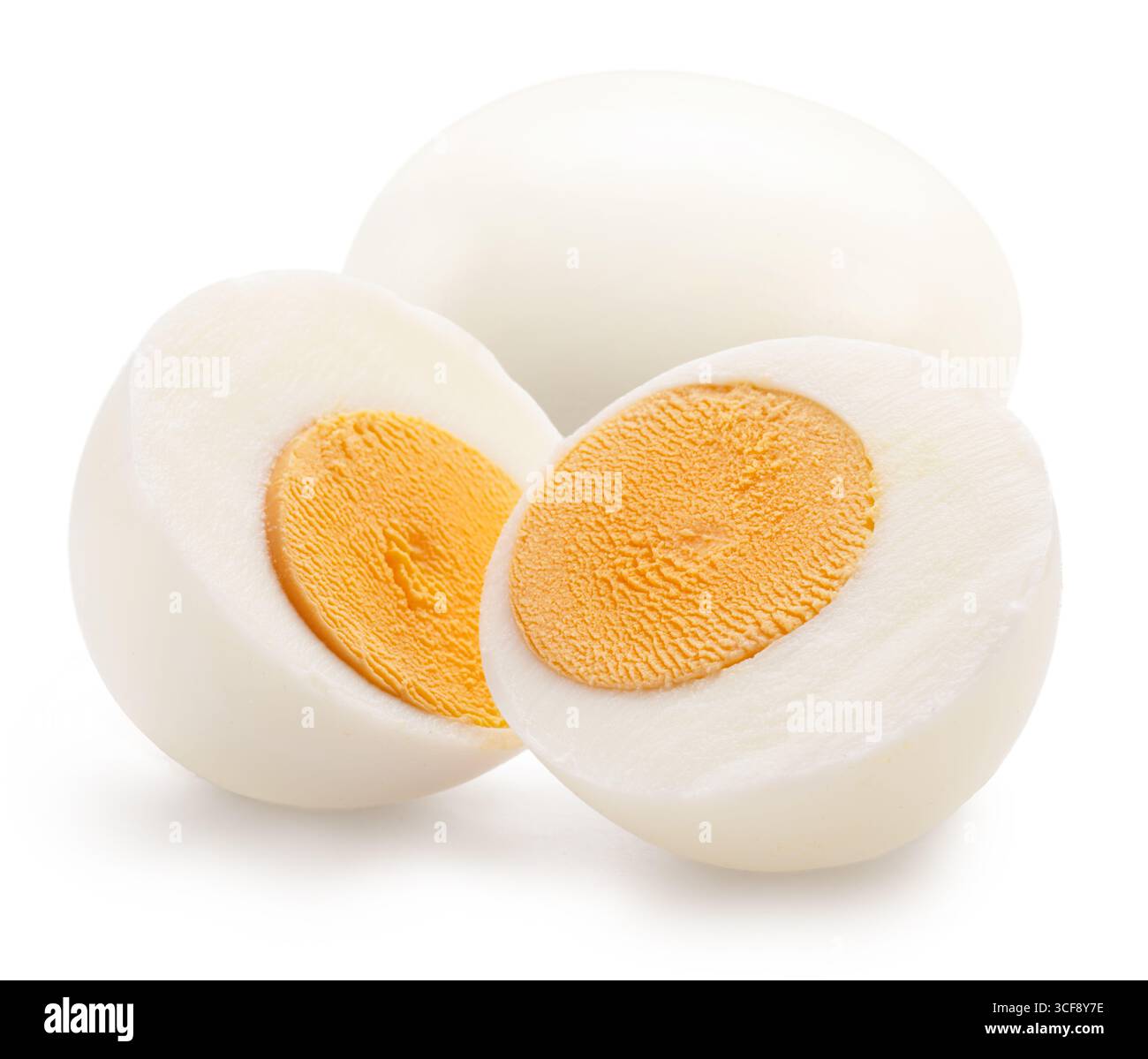 Hard-boiled chicken egg and egg cut in half with yellow hard yolk on ...