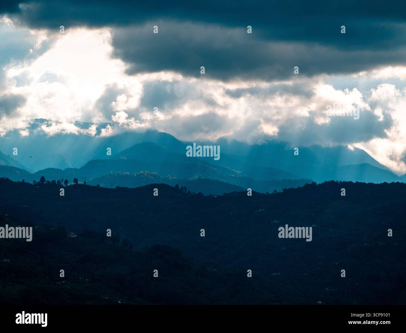 Colombian hills covered with green trees, daylight with dramatic clouds ...