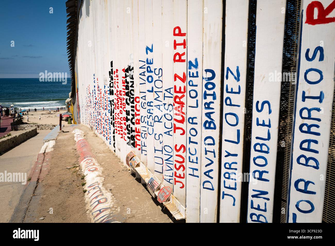 RIP painted metal border fence posts honoring lost loved ones in the Playas de Tijuana beach ...
