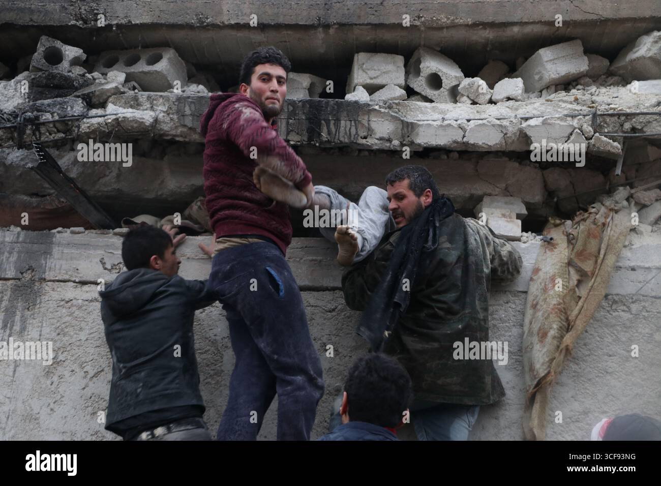 Civil defense teams attempt to rescue civilians trapped under the ...