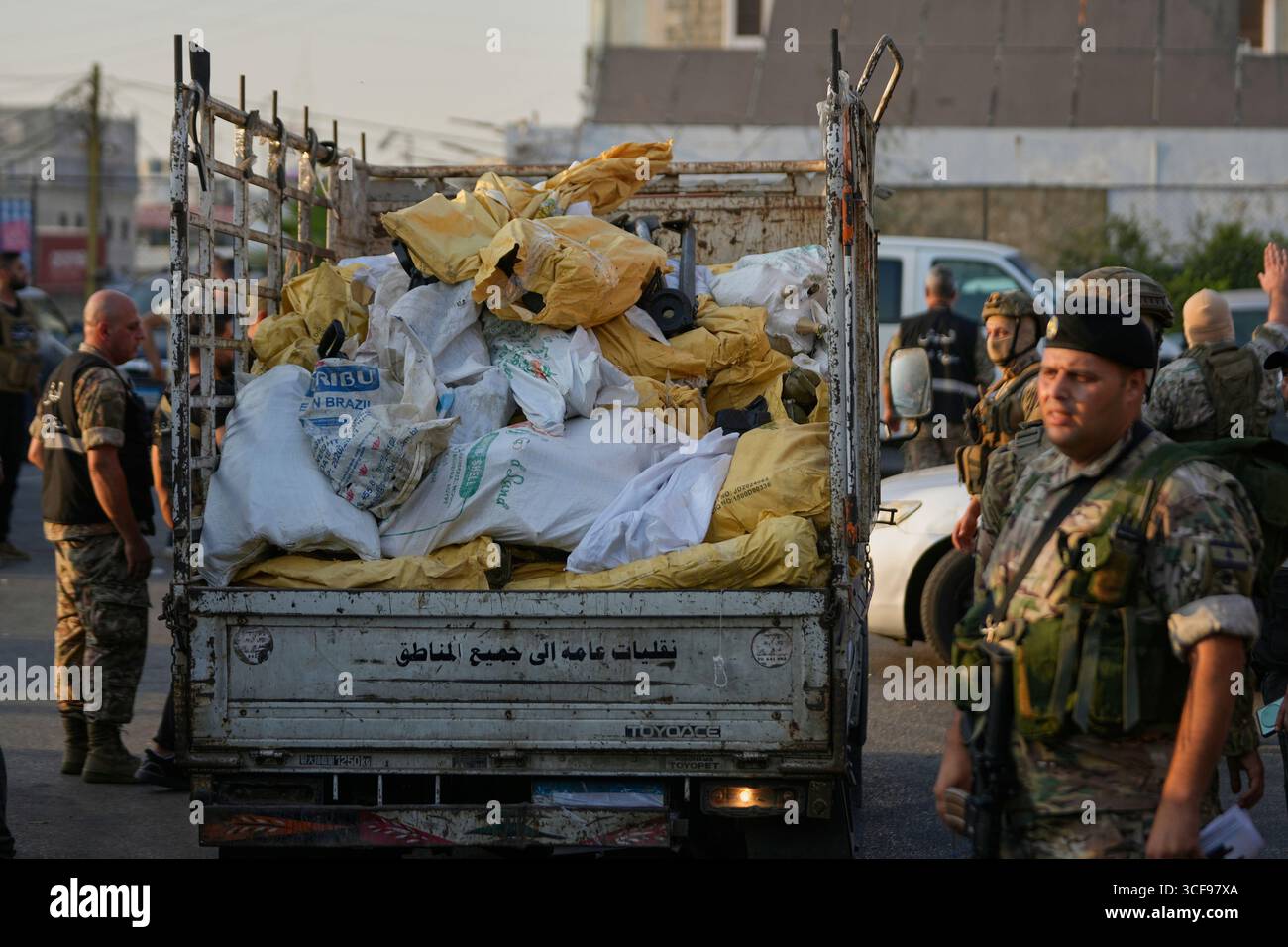 Lebanese army soldiers stand next of a pickup loaded with weapons handed over by Palestinian ...