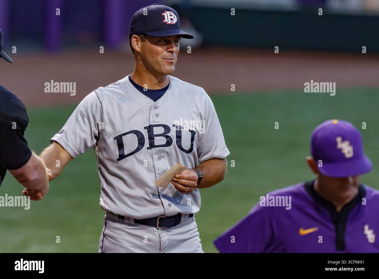 FILE - Dallas Baptist head coach Dan Heefner shakes hands with the ...