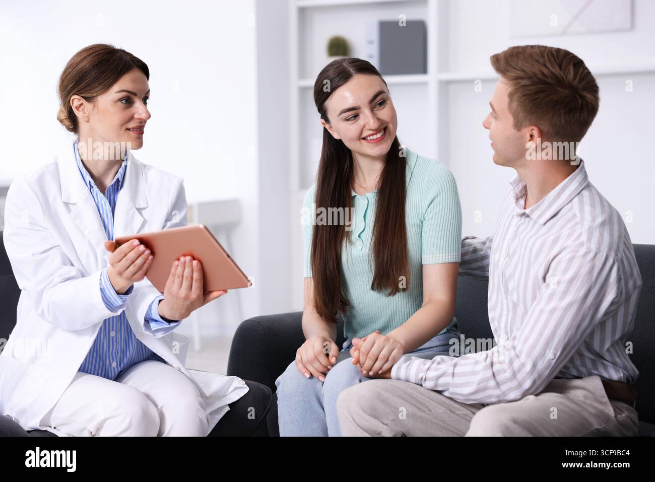 In vitro fertilization (IVF). Happy couple having appointment with ...