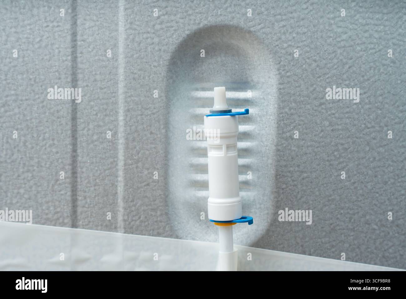 Close-up of the water connection with plastic connector and blue clips ...