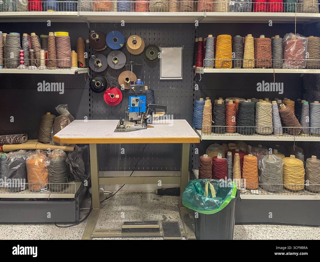 Close-up of workbench with spools of thread. Workbench with a carpet ...