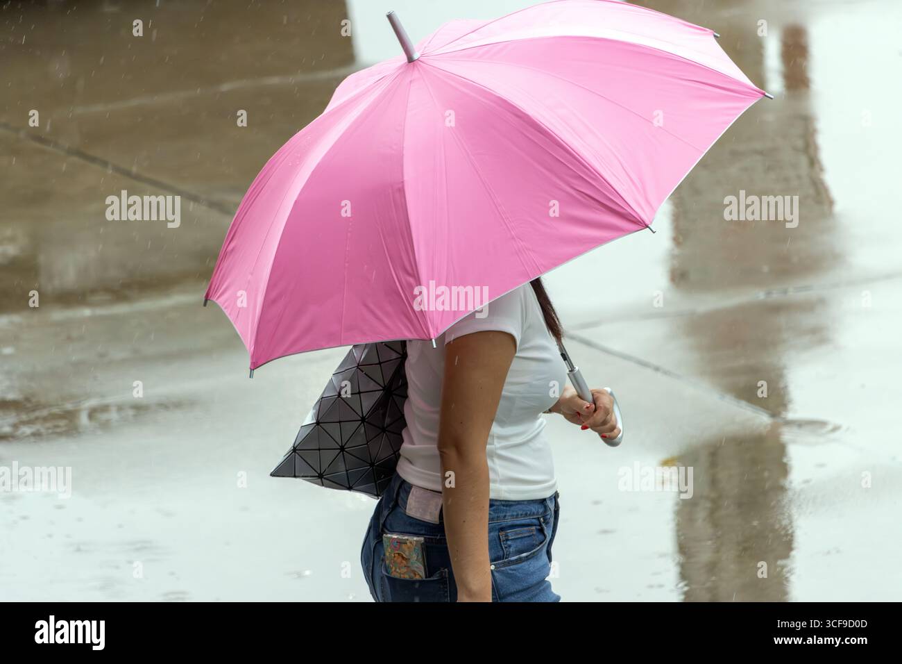 Woman under umbrella walk hi-res stock photography and images - Alamy