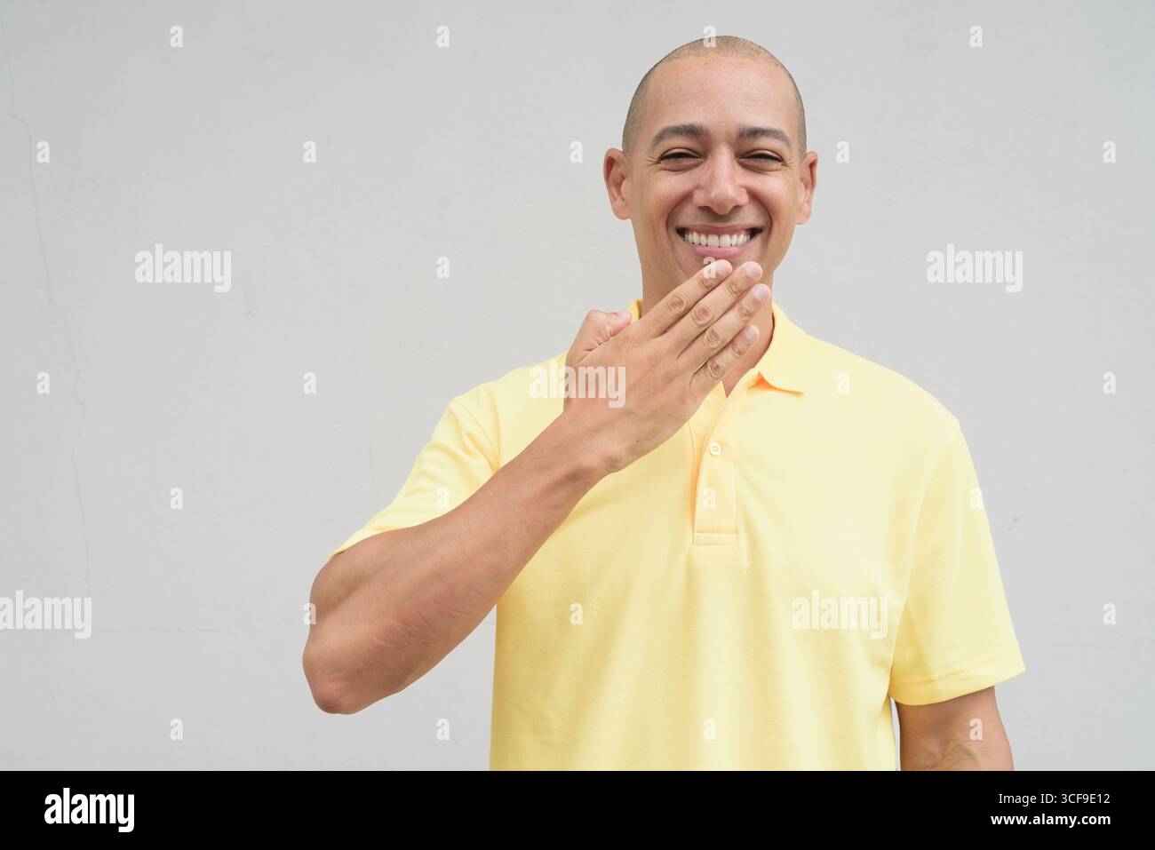 Studio portrait of a handsome mature happy Italian man with shaved head ...