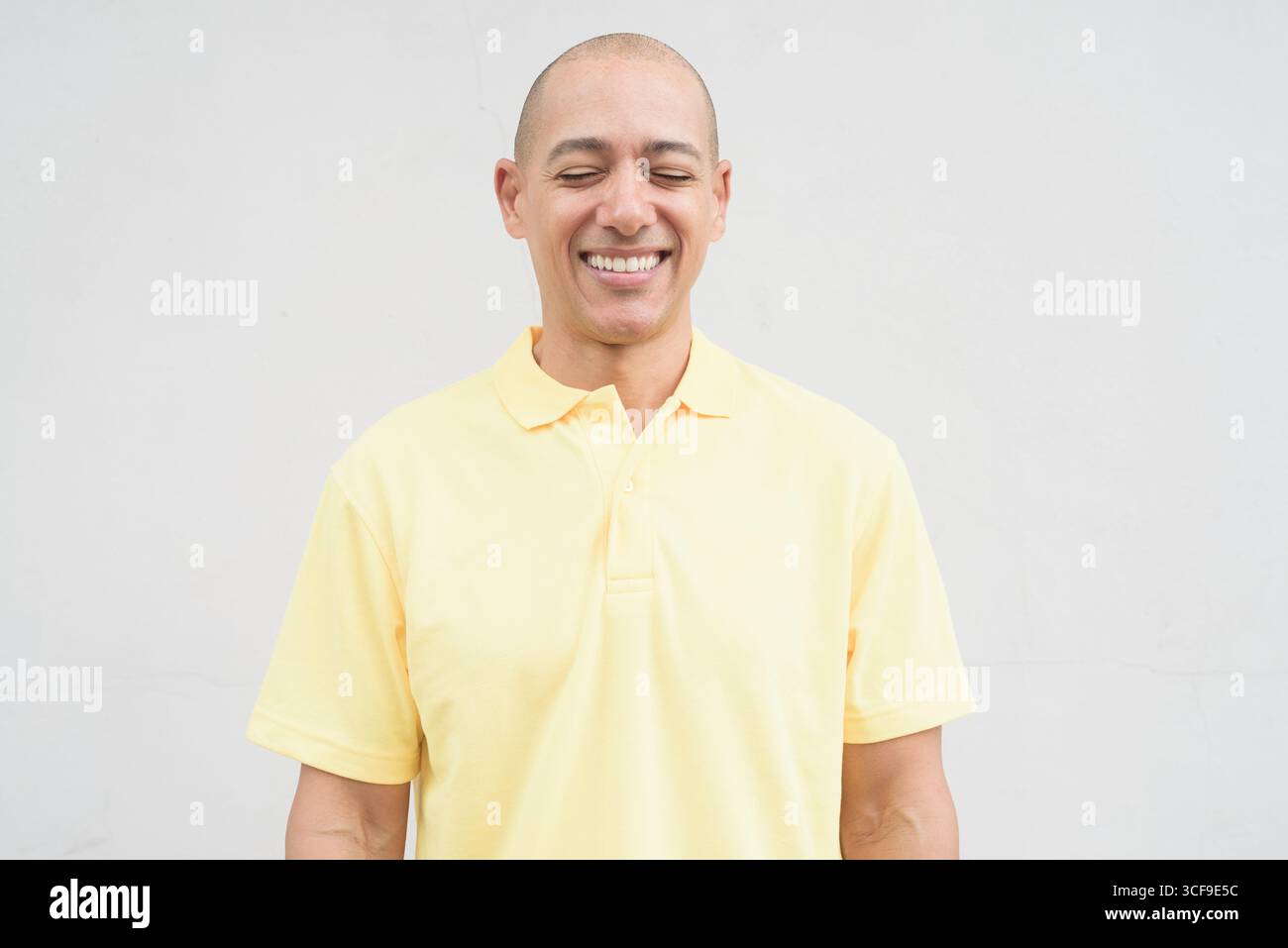 Studio portrait of a handsome mature happy Italian man with shaved head ...