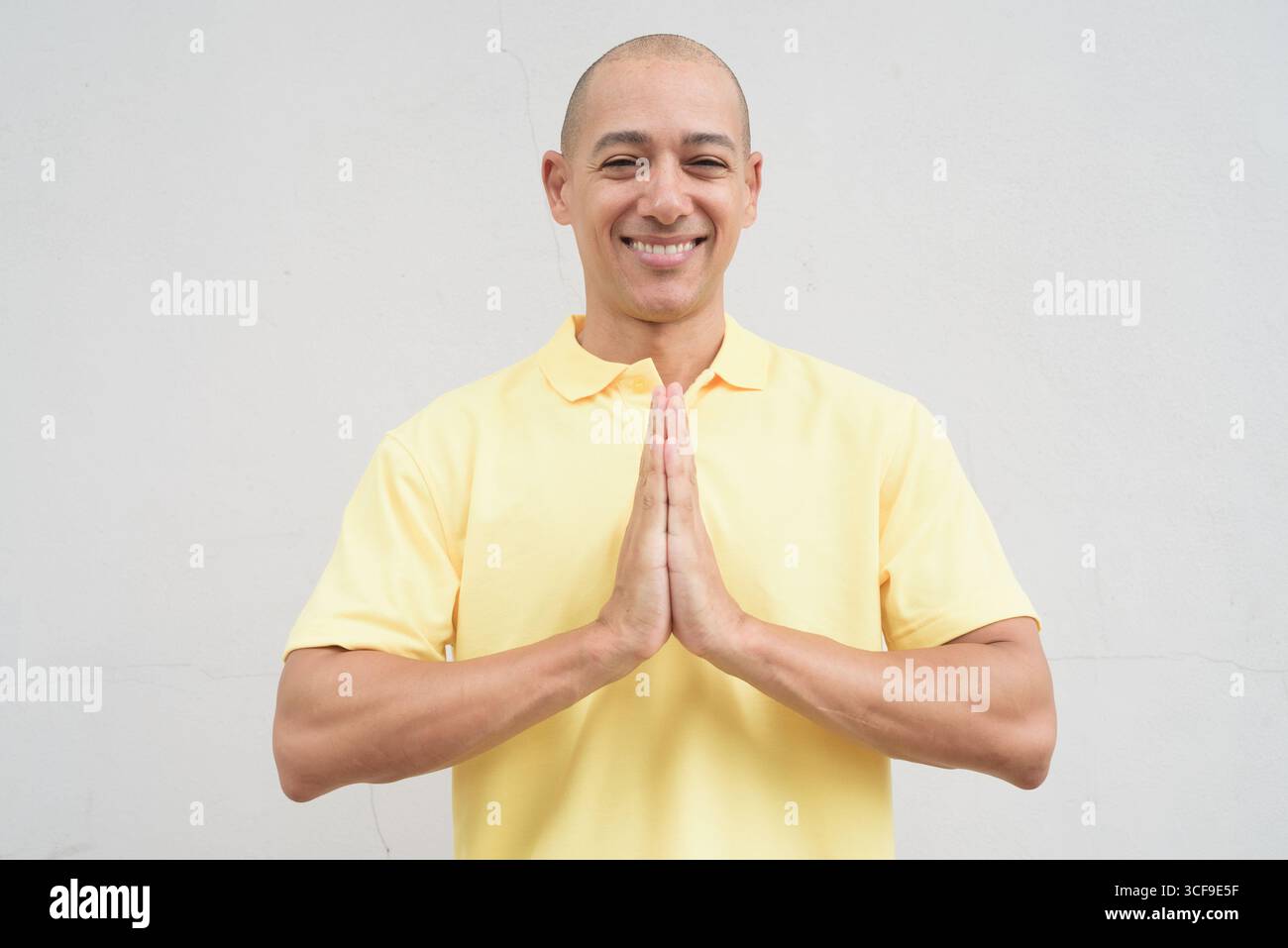 Studio portrait of a handsome mature happy Italian man with shaved head ...