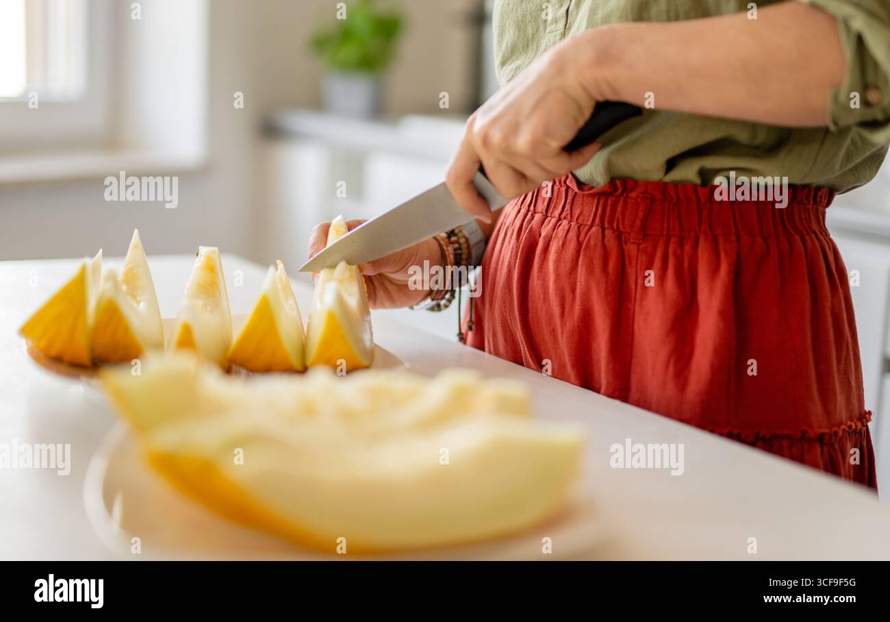 Woman cutting melon close hi-res stock photography and images - Alamy