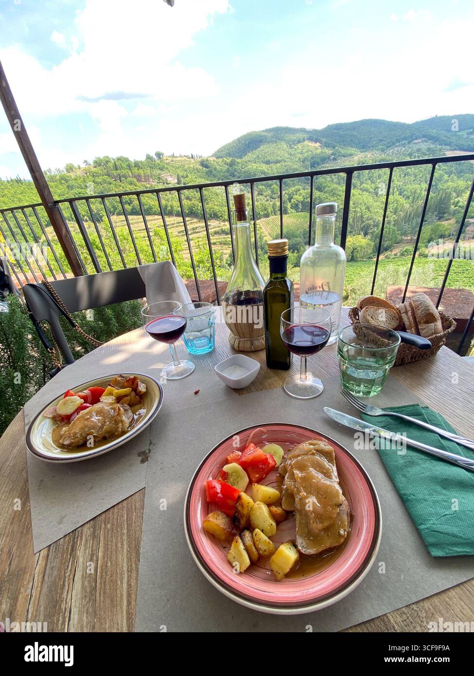 Rustic wooden table set with regional wine, crusty bread, enjoying ...