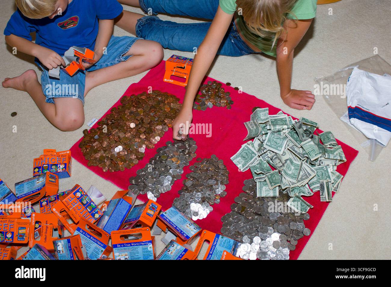 Piles of sorted pennies, nickels, quarters and dollar bills from UNICEF ...