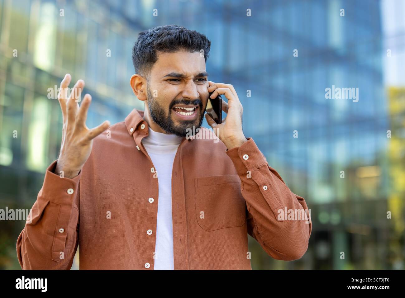 A concerned individual talking on the phone, showing frustration with ...
