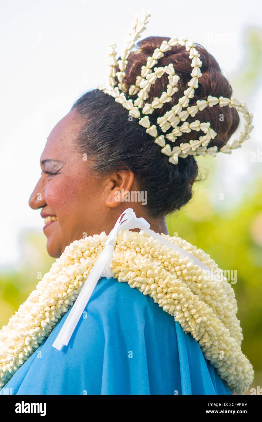 Beautiful female Pa’u rider adorned with flowers in hair on horseback before the start of the ...