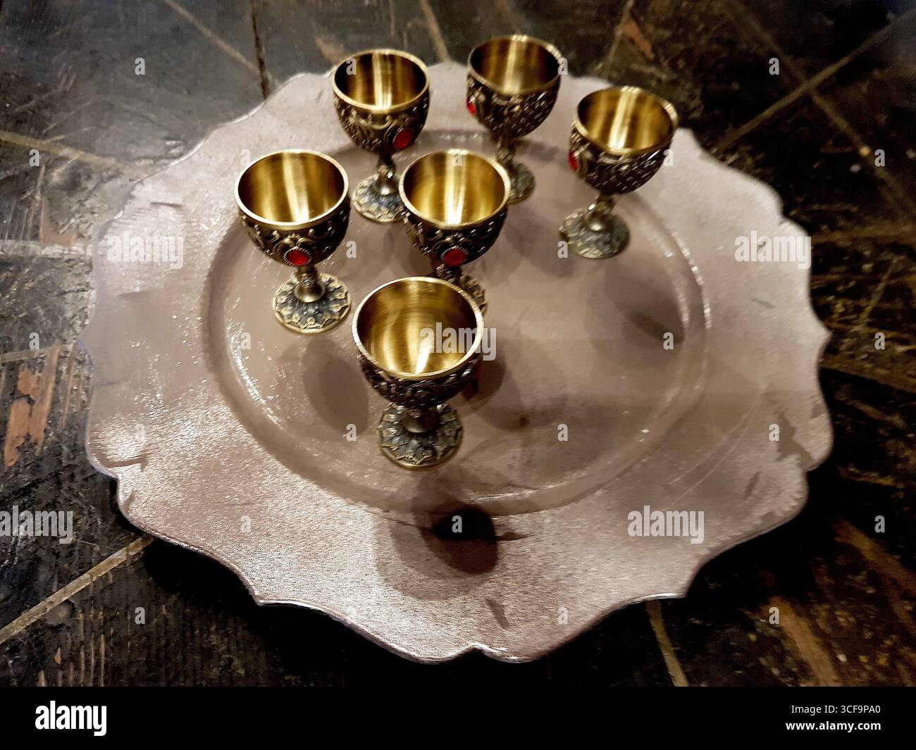 A display showing a medieval goblets on a metal plate Stock Photo - Alamy