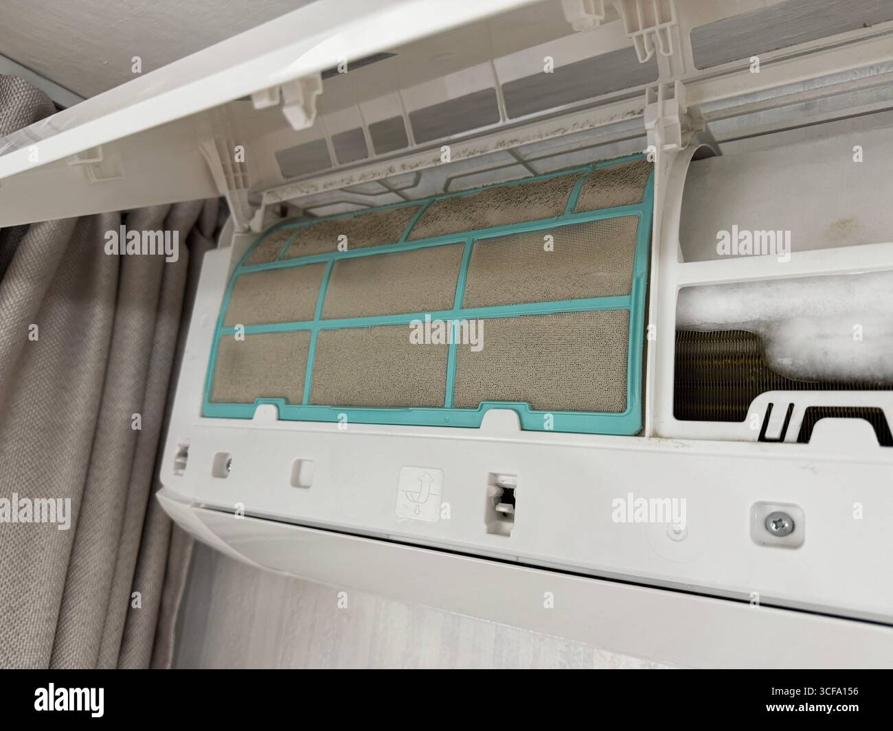 Close up of an air conditioner with a clogged dusty filter and ice ...