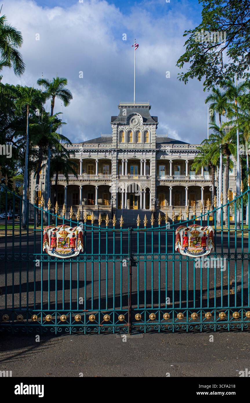 Iolani Palace seen behind ornate wrought iron gates adorned with the ...