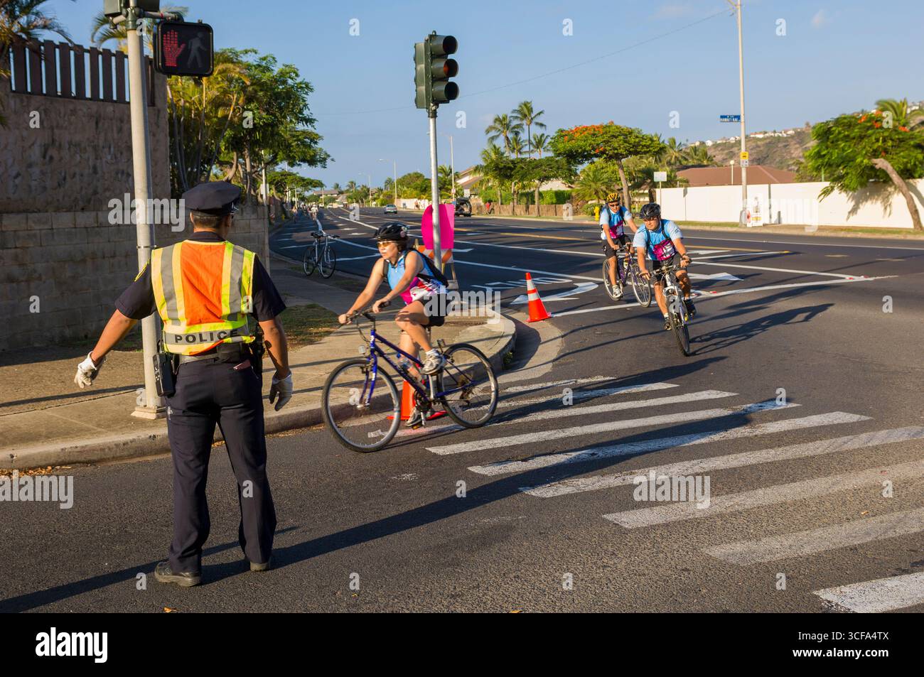 Police officer directing traffic during the 2005 Honolulu Century Ride ...
