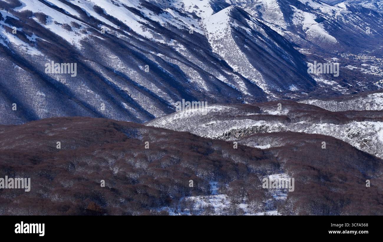 Majestic mountains loom prominently, their snow-covered peaks ...